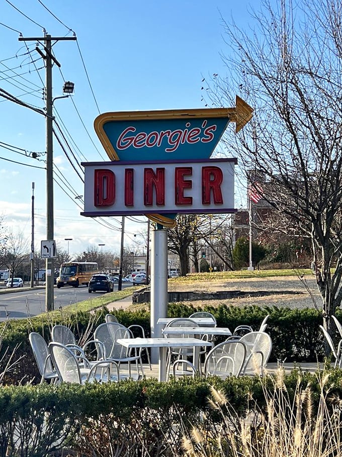 That classic neon sign doesn't just say "Georgie's Diner" – it screams "comfort food ahead" in the universal language of hungry travelers.