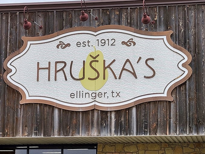 The vintage sign proudly proclaims Hruška's heritage since 1912 – over a century of perfecting the art of making travelers slam on their brakes.