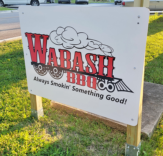The sign says it all: "Always Smokin' Something Good"—a railroad-themed promise that delivers with every succulent, smoky bite.