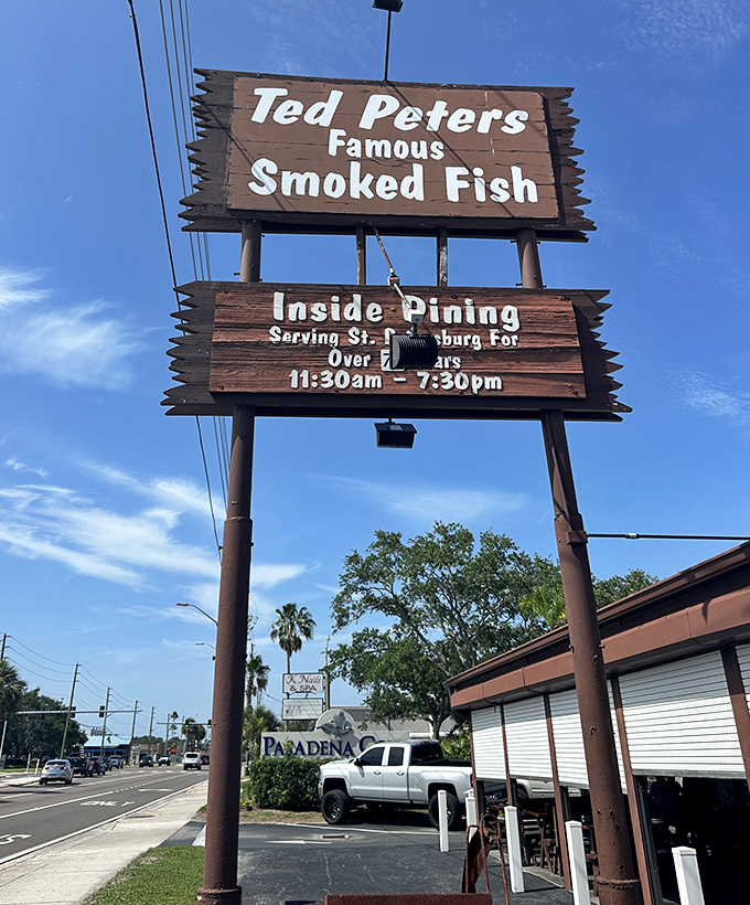 The weathered wooden sign stands like a beacon of hope for hungry travelers—promising smoked fish salvation just off Pasadena Avenue.