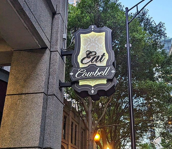 "Eat Cowbell" isn't just a sign—it's life advice worth following. This elegant street marker guides hungry pilgrims to burger salvation.