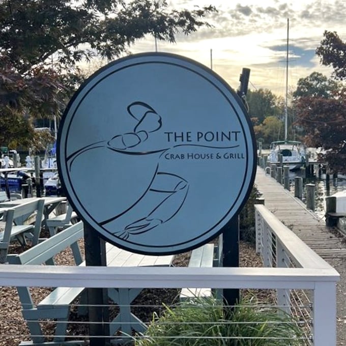 The circular logo captures The Point's essence—hands presenting the bounty of the Chesapeake. A simple symbol for an extraordinary dining experience.