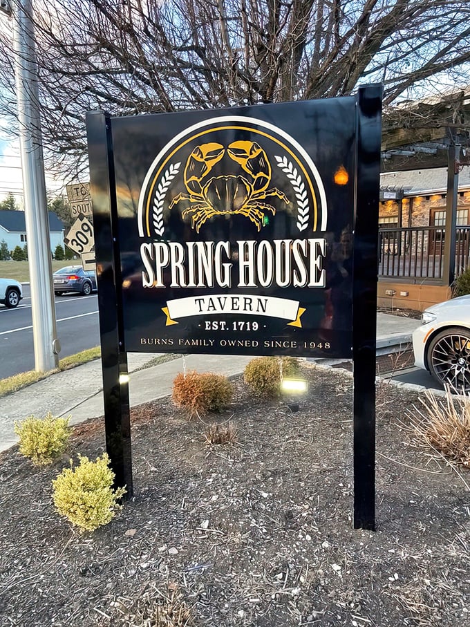The roadside sign proudly displays the tavern's heritage—established 1719, with a golden crab emblem that hints at treasures waiting on the menu inside.