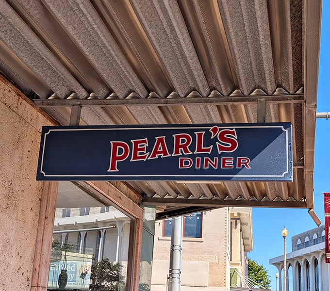 That blue sign doesn't need to be fancy – "PEARL'S DINER" tells you everything you need to know about the goodness waiting inside.