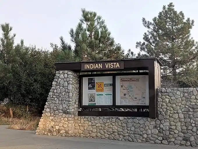 The unassuming gateway to wonder—this stone and wood information kiosk marks the threshold between ordinary day and extraordinary experience.