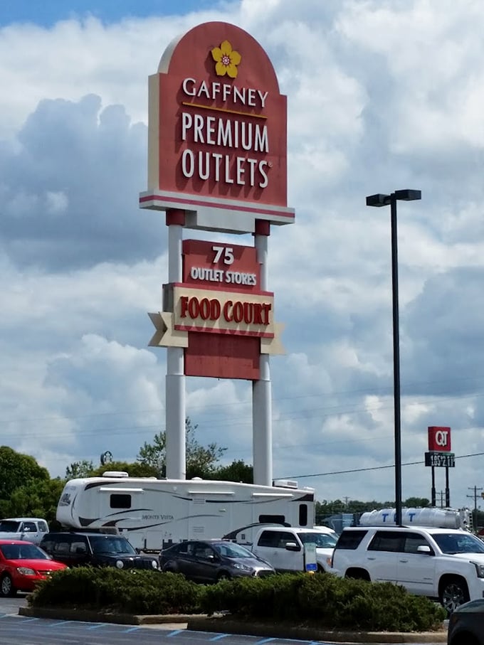 The iconic Gaffney Premium Outlets sign proudly announces "75 Outlet Stores"—a number that simultaneously thrills dedicated shoppers and terrifies reluctant spouses.