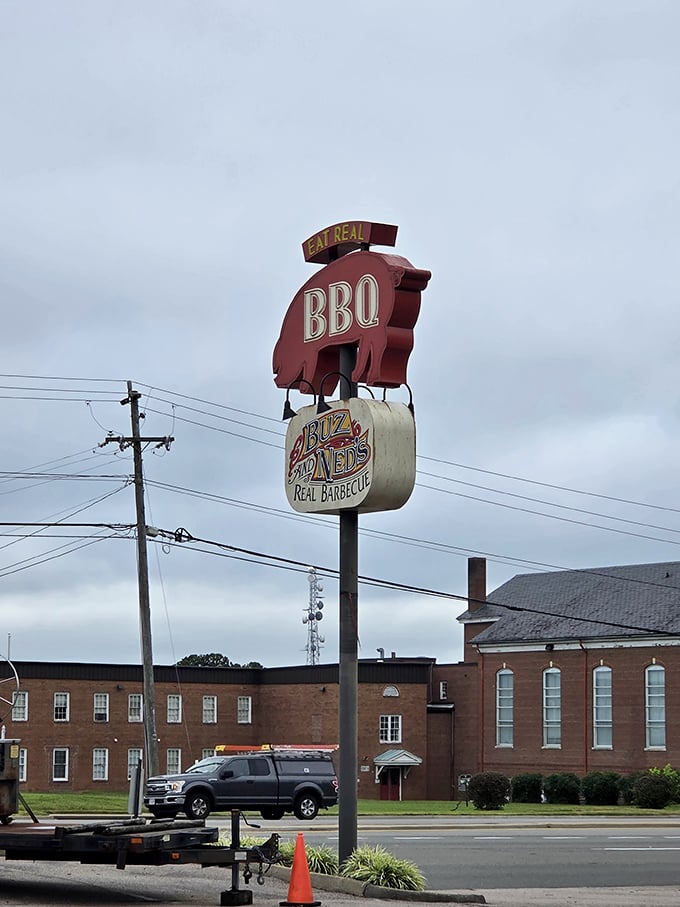 The iconic pig sign holding barbecue sauce stands tall, making highway navigation unnecessary – just follow your nose toward smoke.