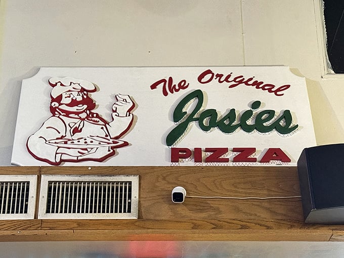 The mascot watching over diners like a benevolent pizza guardian—part chef, part cartoon, all business when it comes to your hunger.