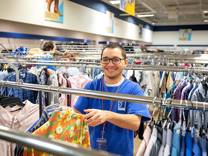 The friendly face of Goodwill – where staff members don't just stock shelves, they help connect communities with affordable goods while supporting the organization's mission of empowerment.