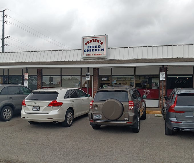The parking lot that's rarely empty. Cars gather like hungry pilgrims at this shrine to fried chicken excellence.