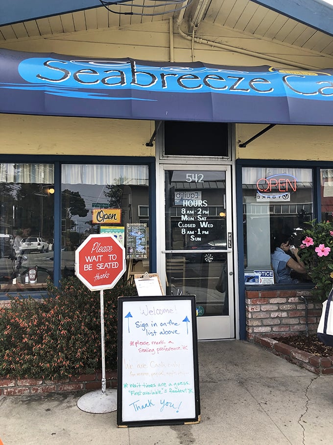 The storefront sign that might as well say "Abandon all diets, ye who enter here"—with hours clearly posted for your breakfast planning needs.