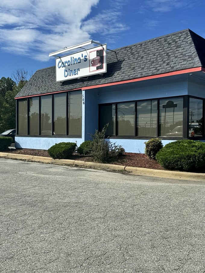 Carolina's Diner's blue exterior stands like a beacon of hope for hungry travelers – a roadside promise of honest food without pretension.