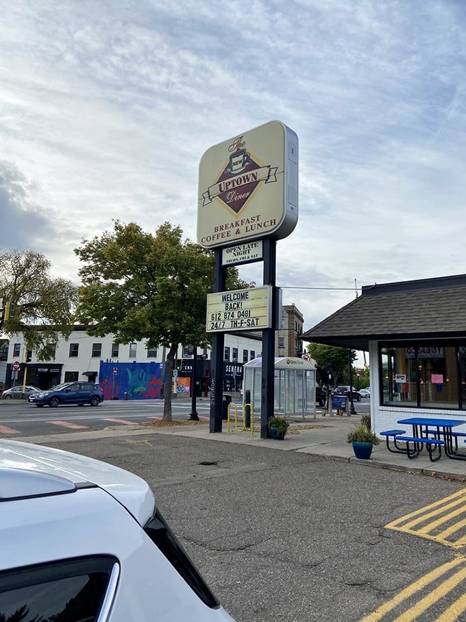 The iconic sign stands tall against Minnesota skies, a landmark for locals who know that true breakfast happiness waits at the corner of 24th and Hennepin.
