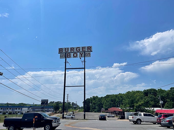 The vintage sign reaches skyward, a roadside promise that burger nirvana awaits just beyond the parking lot.