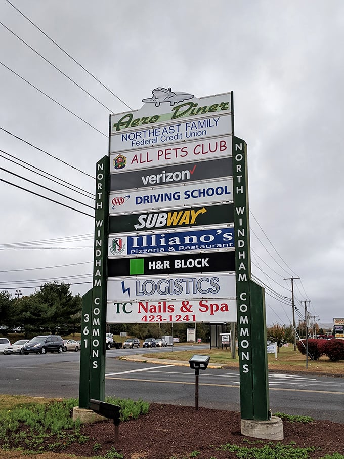 The roadside sign announces the Aero Diner's presence among everyday businesses. Like finding a Broadway star in your local community theater—unexpected excellence.