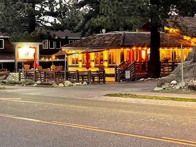 As evening falls, The Warming Hut glows like a beacon for hungry travelers—a mountain jewel wrapped in twinkling lights.