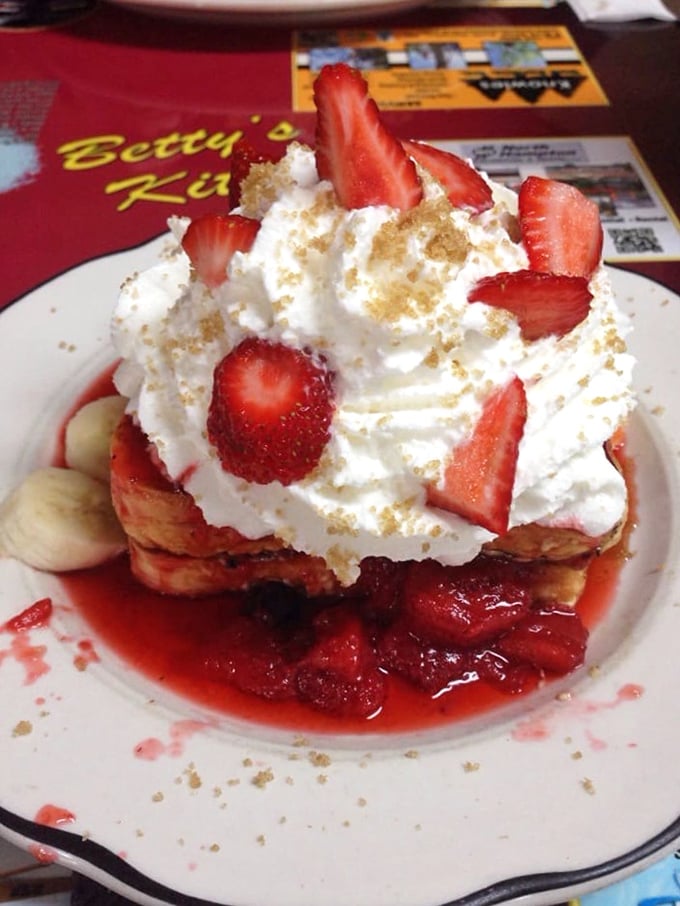 Stuffed French toast that makes ordinary breakfast seem like a missed opportunity. Those strawberries aren't garnish – they're ruby jewels in a crown of whipped cream.
