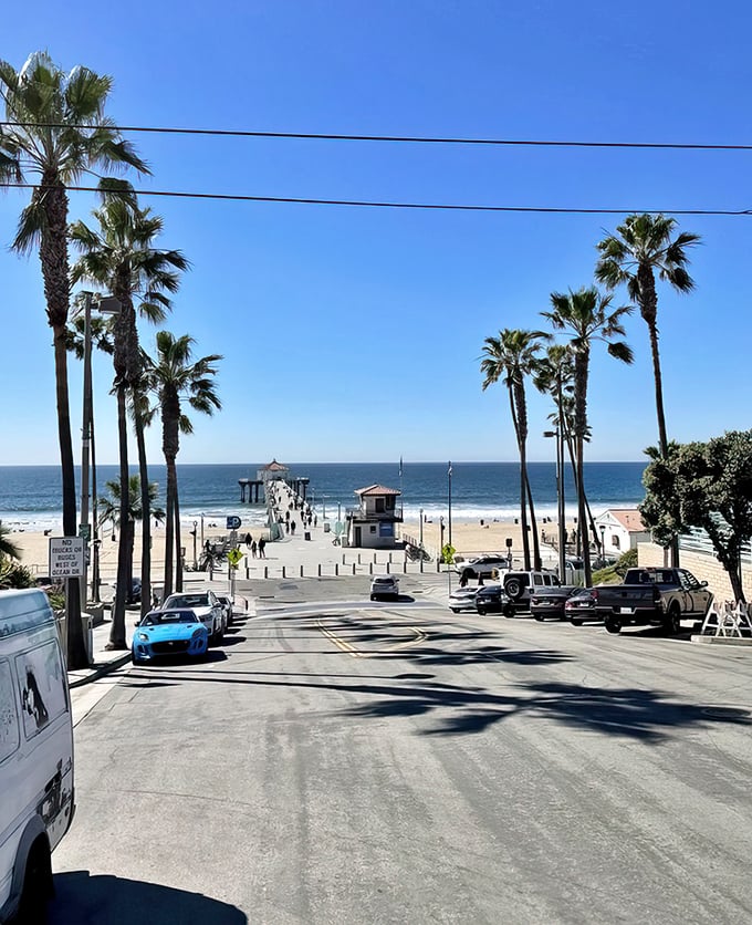 This is what you came for—Manhattan Beach in all its palm-tree-lined glory, with that iconic pier stretching toward the horizon like a runway for dreams.
