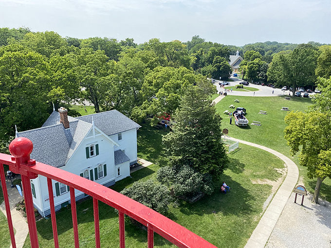 The view lighthouse keepers enjoyed for two centuries—a panoramic vista of green lawns, winding paths, and visitors making memories below.