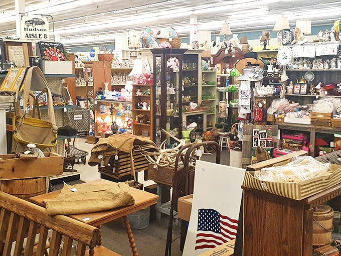 The "Hudson Aisle 8" sign marks a neighborhood of nostalgia where furniture from three generations ago waits for its comeback tour.