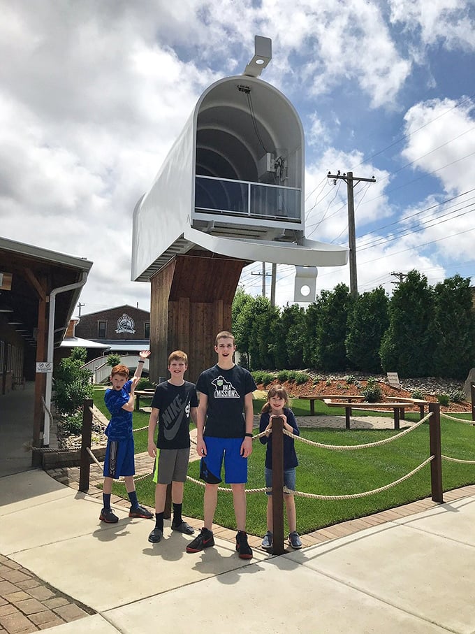 Families create lasting memories beneath this towering testament to everyday objects made extraordinary. "Stand tall," the mailbox seems to whisper, "and dream bigger."
