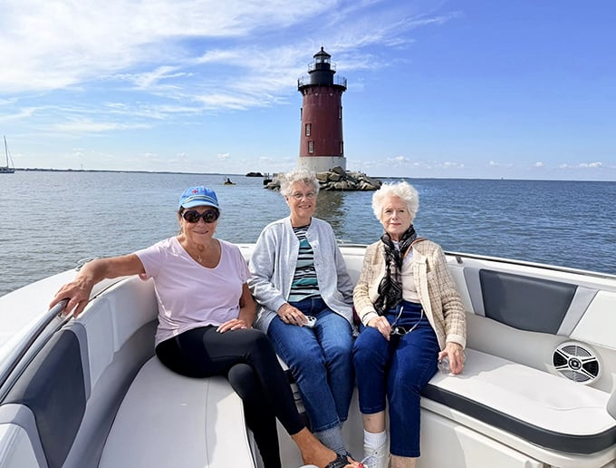 Three generations of lighthouse enthusiasts sharing stories on the water. Some family traditions don't need explanation—just a boat and a beautiful day.