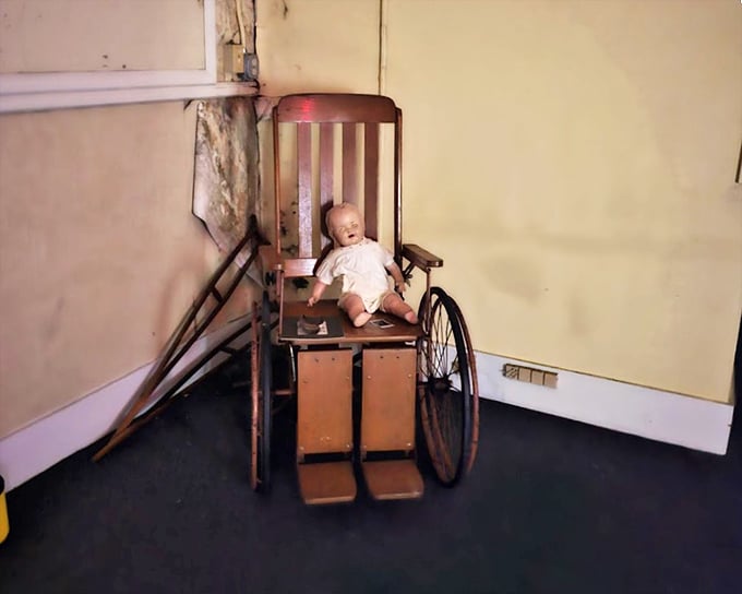 Perhaps the most disturbing artifact—a child's wheelchair with doll. Some say this arrangement appears differently each morning, though no one admits to moving it.