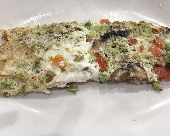 A veggie-packed egg white omelet that somehow makes healthy eating feel indulgent—the diner's nod to modern appetites.