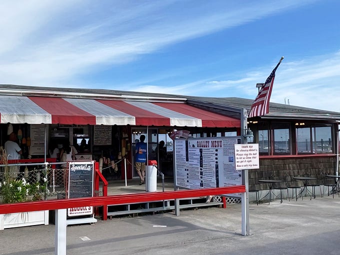 Abbott's iconic red-striped awning isn't just for show—it's a beacon calling seafood lovers home to lobster roll paradise.