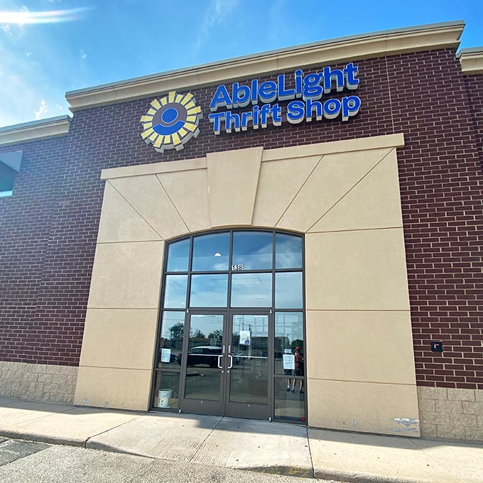 That cheerful sunburst logo practically winks at you from this pristine brick facade, promising treasures within.