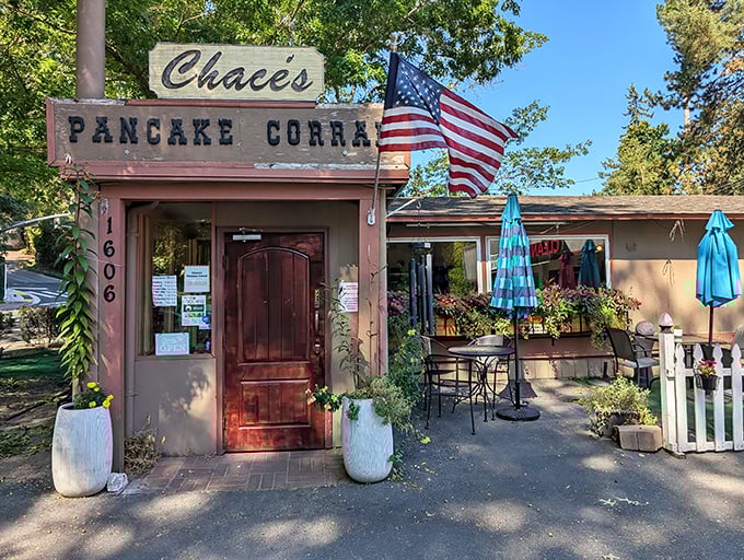 The rustic charm of Chace's Pancake Corral beckons with its wooden facade and American flag – breakfast paradise awaits!