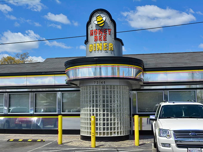 The Honey Bee Diner's iconic yellow sign buzzes with promise, its classic chrome exterior gleaming like a time machine to simpler days.