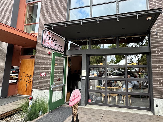 That pink ice cream cone sculpture says it all – this place means business about frozen treats and hot pizza.