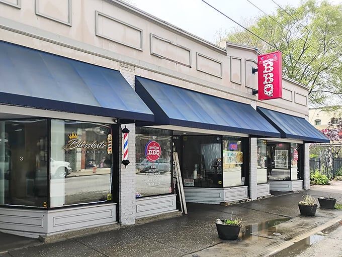 That blue awning beckons like a BBQ beacon - Real Smoq'ed's storefront promises serious smoke ahead.
