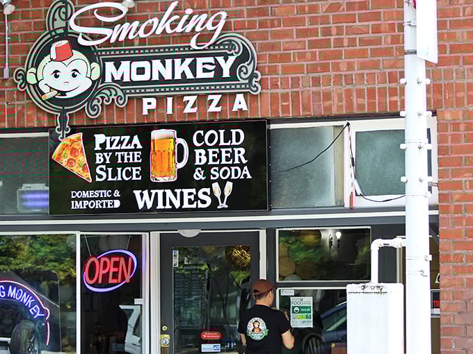 That cheerful monkey knows something you don't – the best pizza secrets hide behind brick walls.