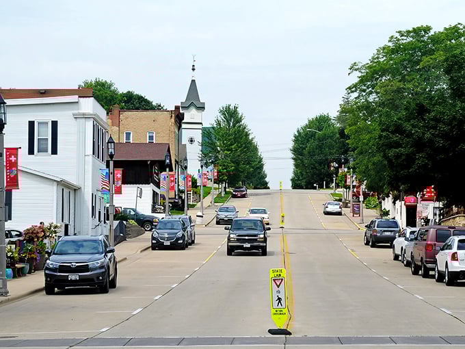 Downtown New Glarus welcomes visitors with its pristine main street, Swiss flags fluttering in the breeze, and a church steeple that seems to keep watch over this Alpine oasis.