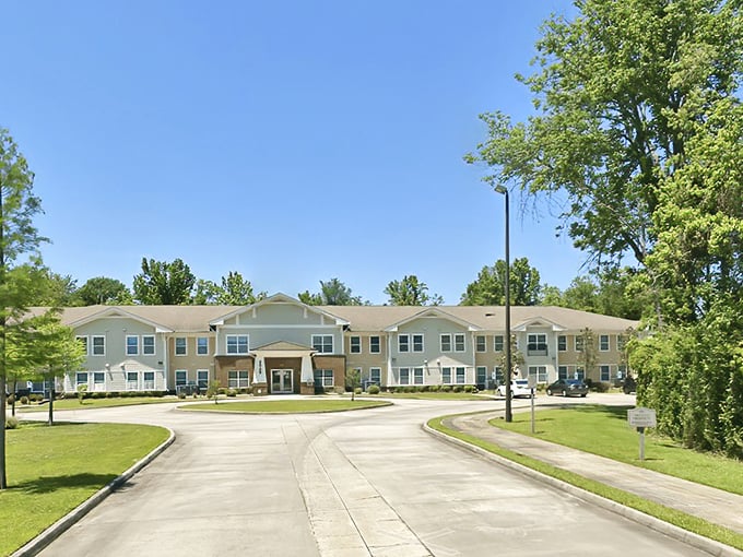 The Gardens Senior Apartments welcomes you with tree-lined grounds that promise peaceful days ahead in Baton Rouge.