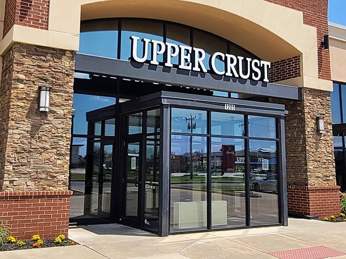 Upper Crust's welcoming entrance promises wood-fired delights within. That stone and brick exterior isn't just for show—it's a hint of the warmth waiting inside.