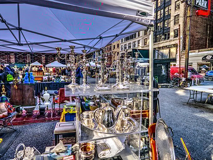 Silver treasures gleam under city skies - someone's grandmother's tea set awaits its next loving home.