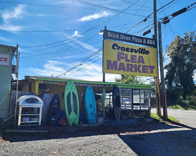 Colorful kayaks stand guard outside Crossville Flea Market – perhaps the most honest advertising ever: "Adventure sold here!"
