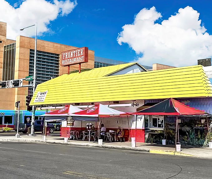 Frontier's yellow awning and outdoor seating area—where green chile dreams and college memories are made in equal measure.