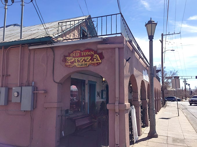 Where history and hunger meet! The pink adobe façade of Old Town Pizza Parlor beckons with promises of cheesy delights inside.