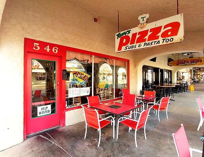 Those red outdoor tables aren't just seating—they're front-row tickets to Boulder City's best pizza show.