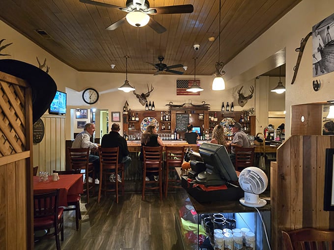 Step inside and you're transported to a time when wood-paneled walls, mounted trophies, and ceiling fans were the height of dining sophistication—and somehow, it still works.