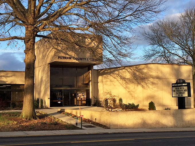 The Putnam County Library stands as a modern sanctuary of knowledge, where sunlight plays across its distinctive façade at golden hour.