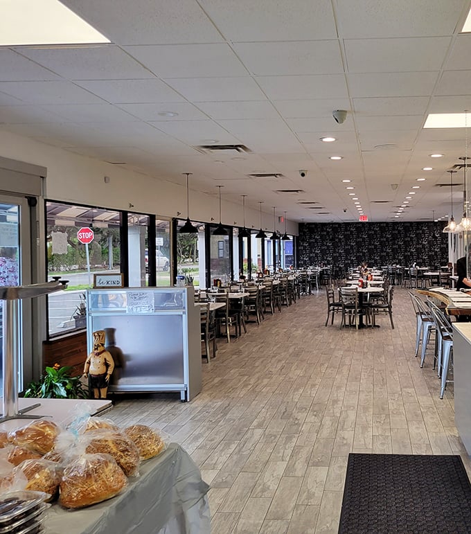 Spacious, bright, and ready for the breakfast rush. The wood-toned floors and black accent wall create the perfect backdrop for deli drama.
