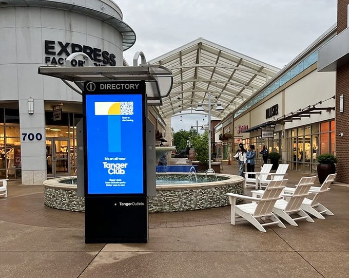 This isn't just a directory—it's a treasure map. The fountain and Adirondack chairs create a perfect resting spot for weary bargain hunters between retail victories.
