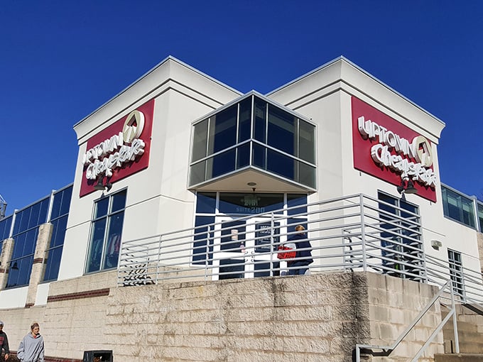 The modern storefront beckons like a fashion oasis in the retail desert. Red signage promises treasures within that won't empty your wallet.