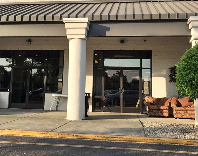That couch outside isn't just furniture—it's a preview of the adventures awaiting inside. The thrift shop's welcoming entrance sets the tone for treasure hunting.