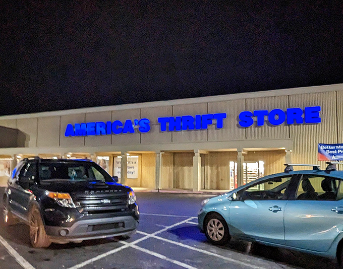 Even after dark, the blue glow of thrift store possibility illuminates the parking lot, promising tomorrow's adventures in secondhand splendor.